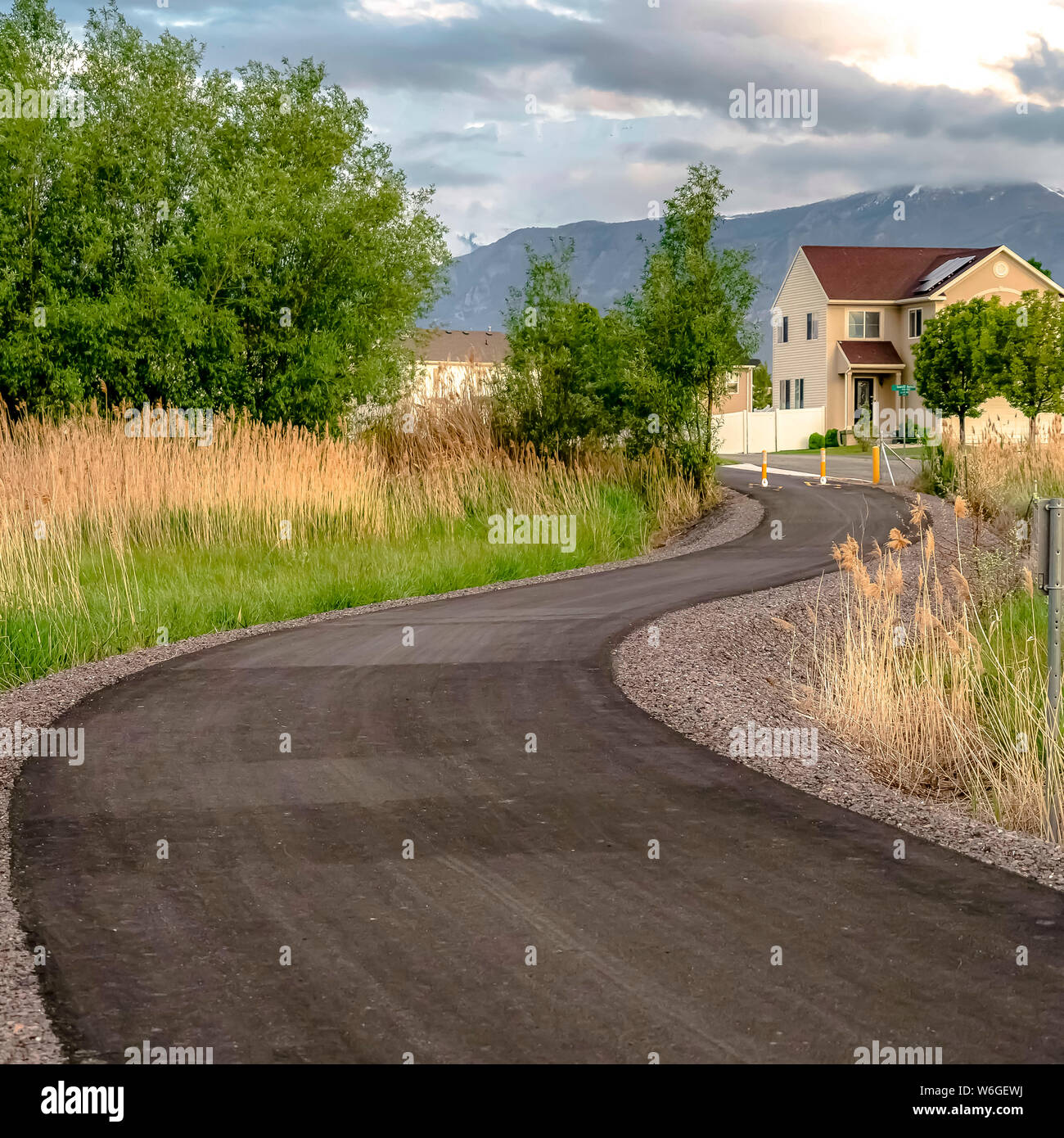 Square frame Paved road with yellow traffic delineator posts winding ...