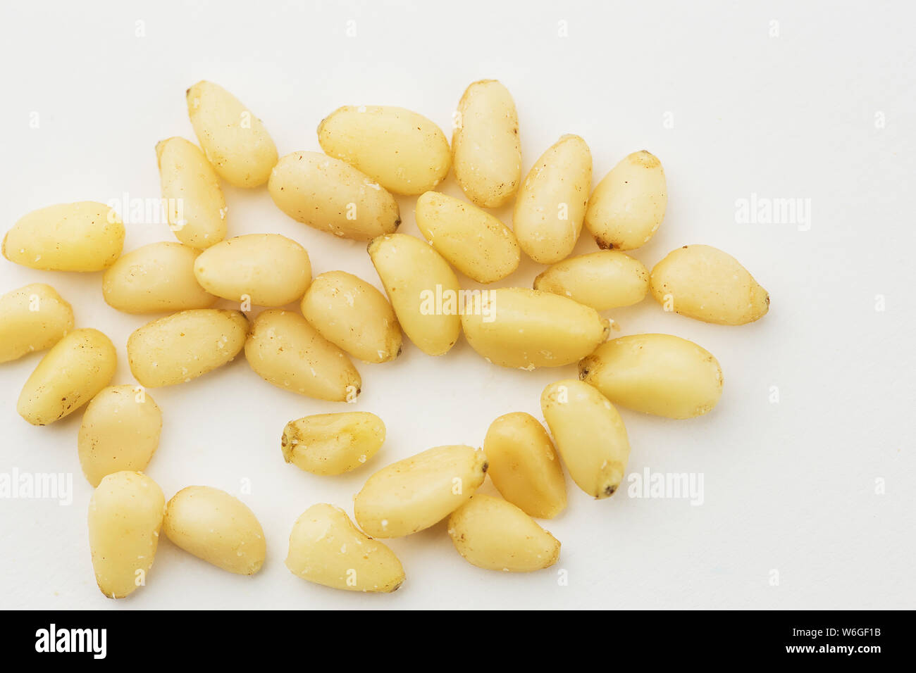 Cedar Pine nuts on a white background Stock Photo - Alamy