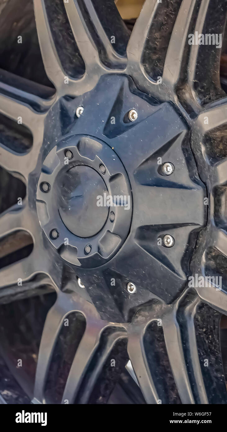 Vertical frame Close up view of the black rubber wheel of a vehicle ...