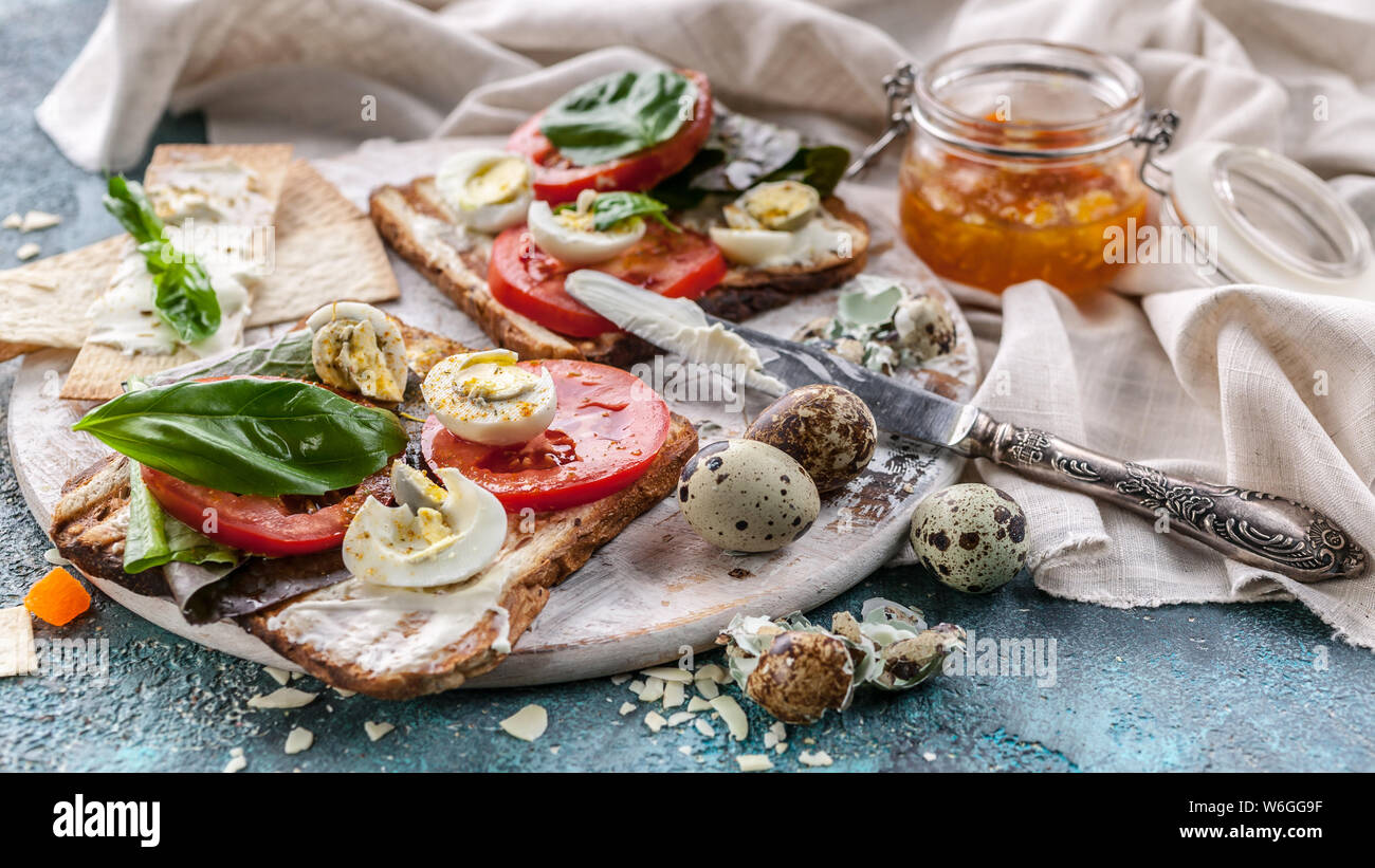 Food banner italian toasts with cheese, tomatoes, basil, quail eggs ...