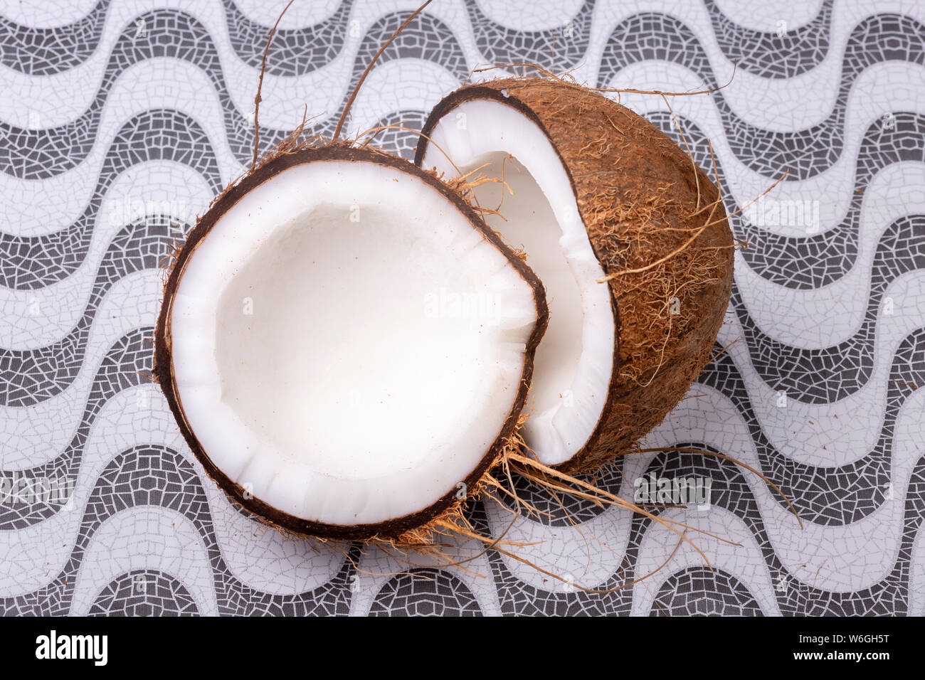 Close up of two coconut halves tightly together with the outer brown ...