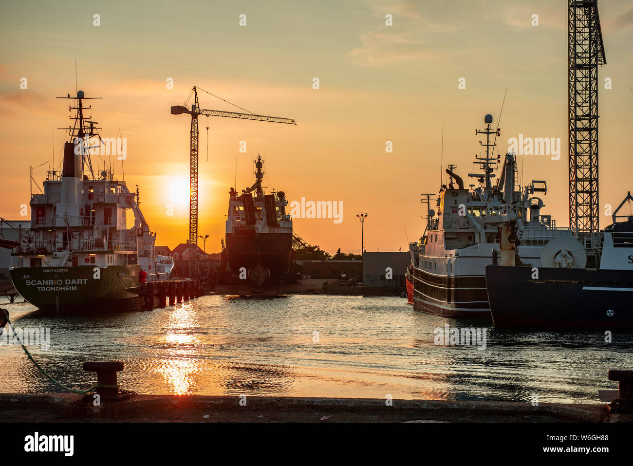 Commercial fishing boats in the sunset at Skagen in Denmark Stock Photo ...