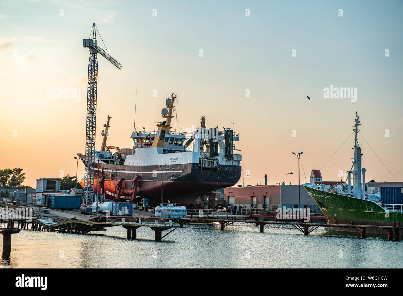 Commercial fishing boats in the sunset at Skagen in Denmark Stock Photo ...