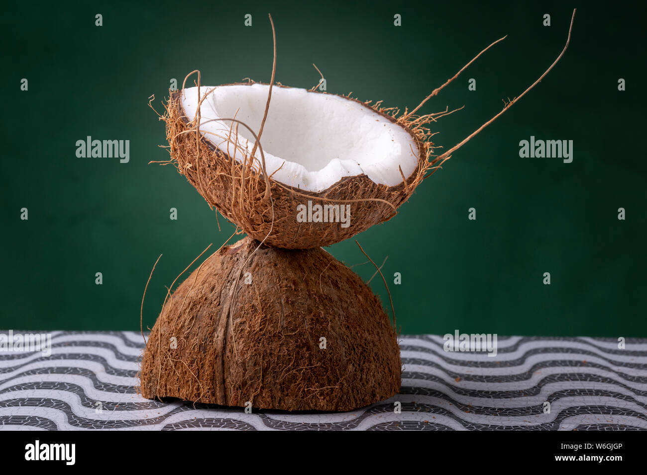 Close up of two halves of a coconut forming a chalice with the outer ...