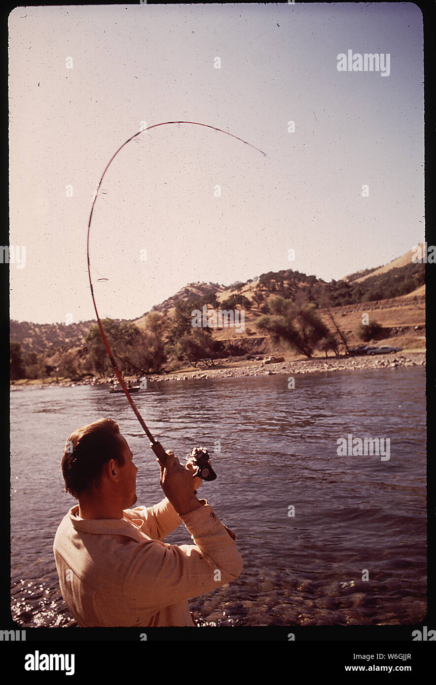English: Fishing for Rainbow Trout below dam Stock Photo - Alamy