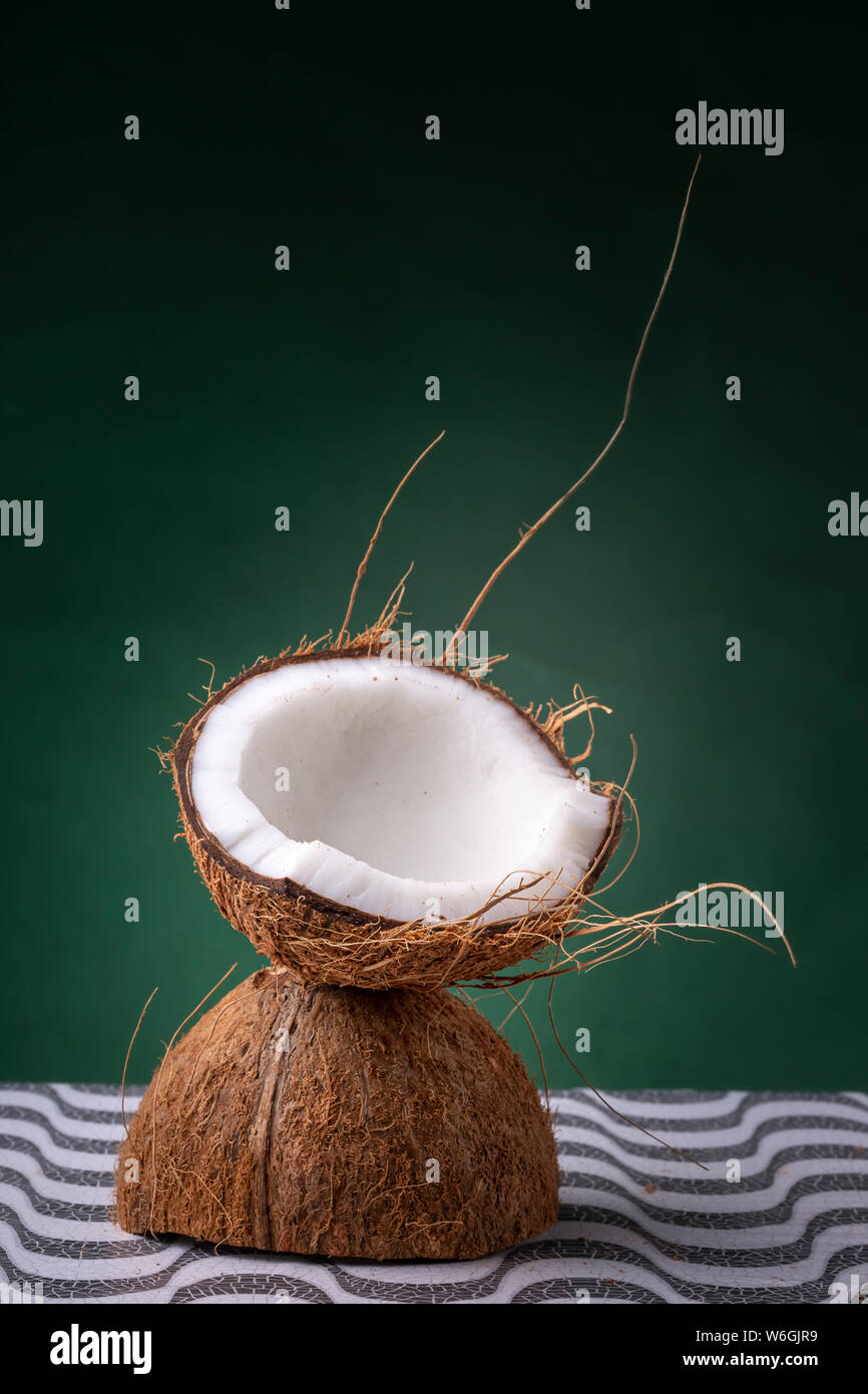 Coconut halves forming a chalice with the outer brown shell and inner ...