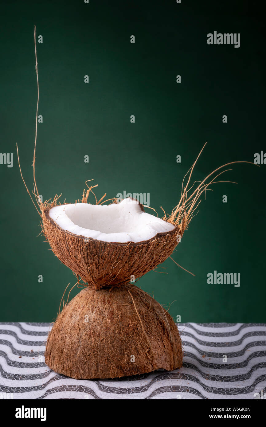 Coconut halves forming a chalice with the outer brown shell and inner ...