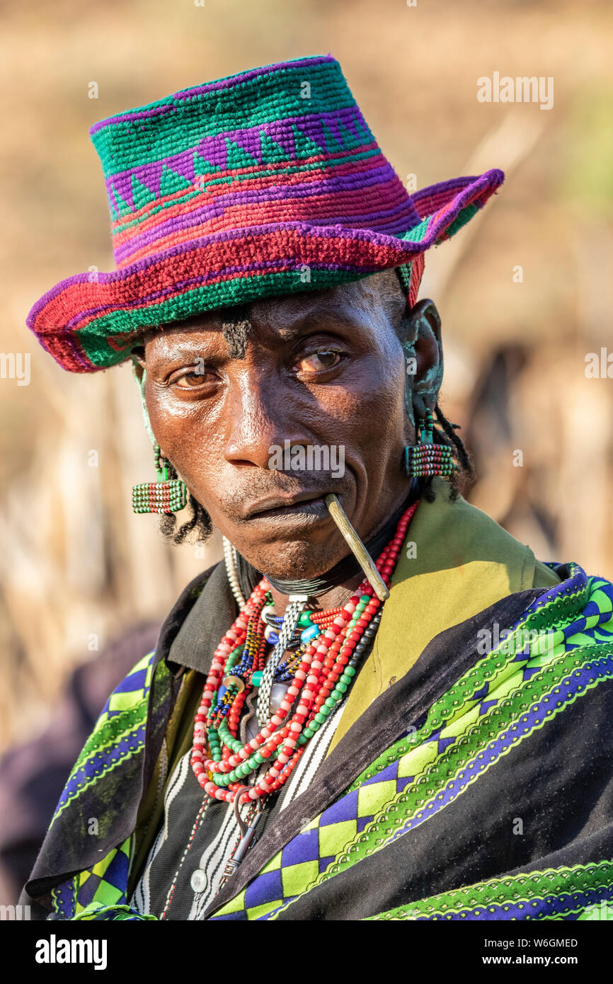 Hamer man wearing a colourful hat at a bull jumping ceremony, which ...