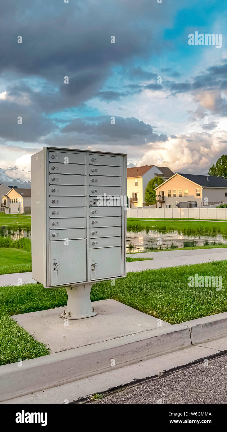 Vertical Mailbox on the side of the road with pond grassy terrain and ...