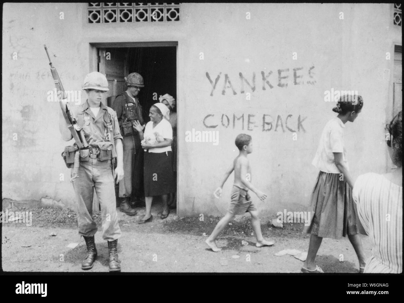 Food distribution in front of Yankees come back sign, Santo Domingo ...