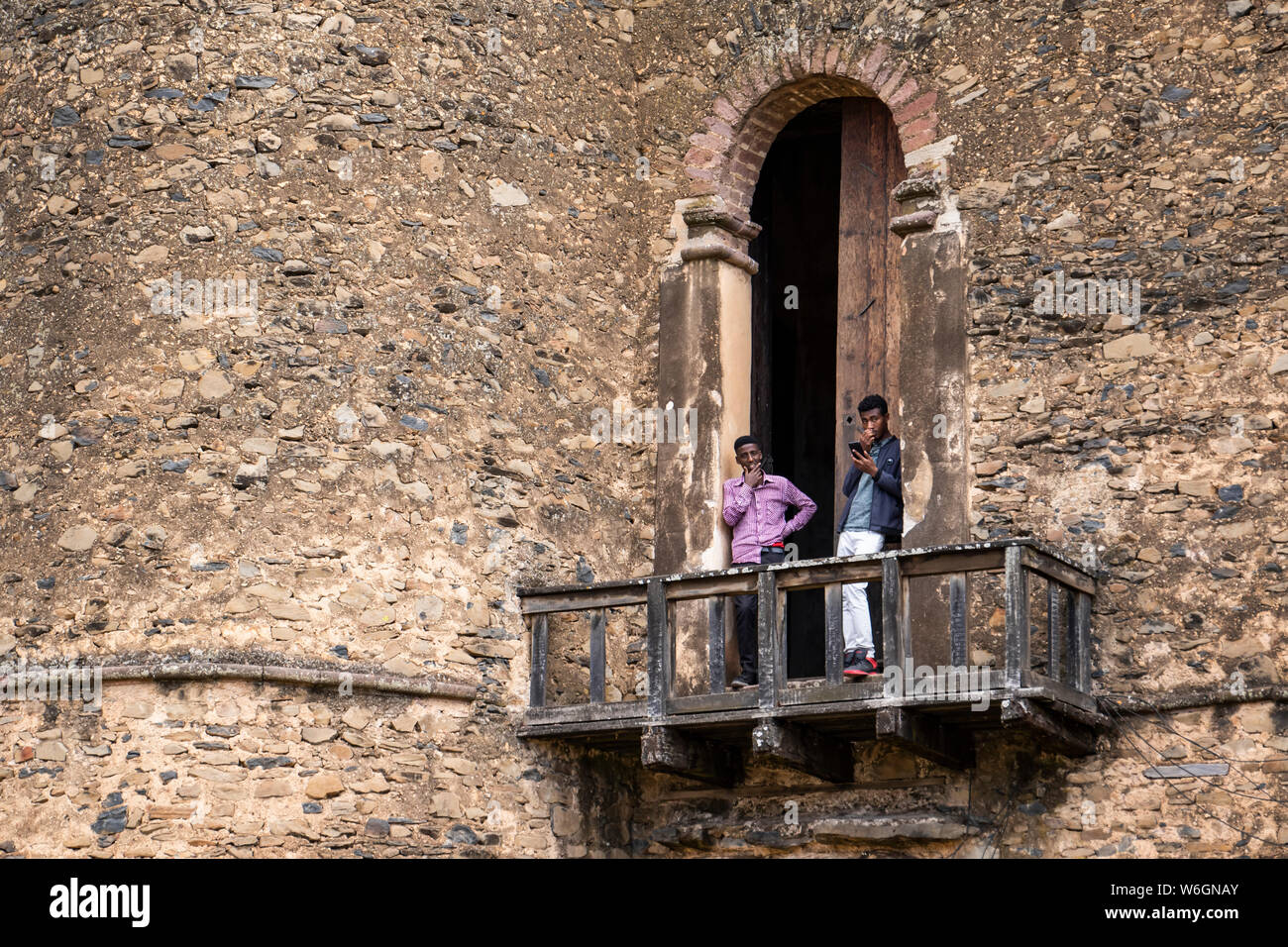 Ethiopian men on a balcony of Fasilides Castle, founded by Emperor ...