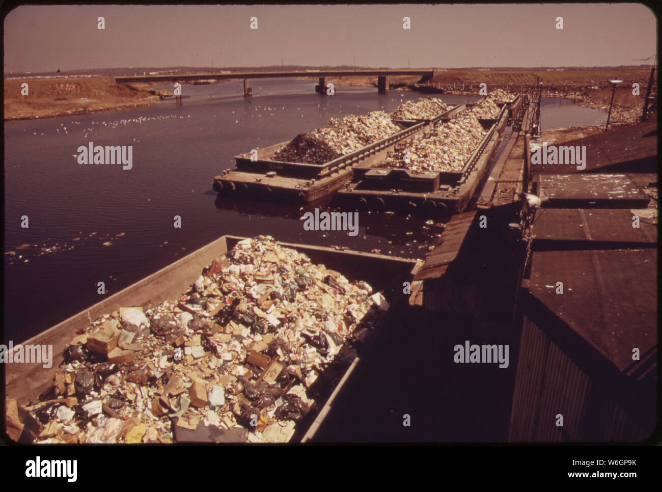 GARBAGE SCOWS FROM MANHATTAN WAIT TO BE UNLOADED AT THE STATEN ISLAND ...