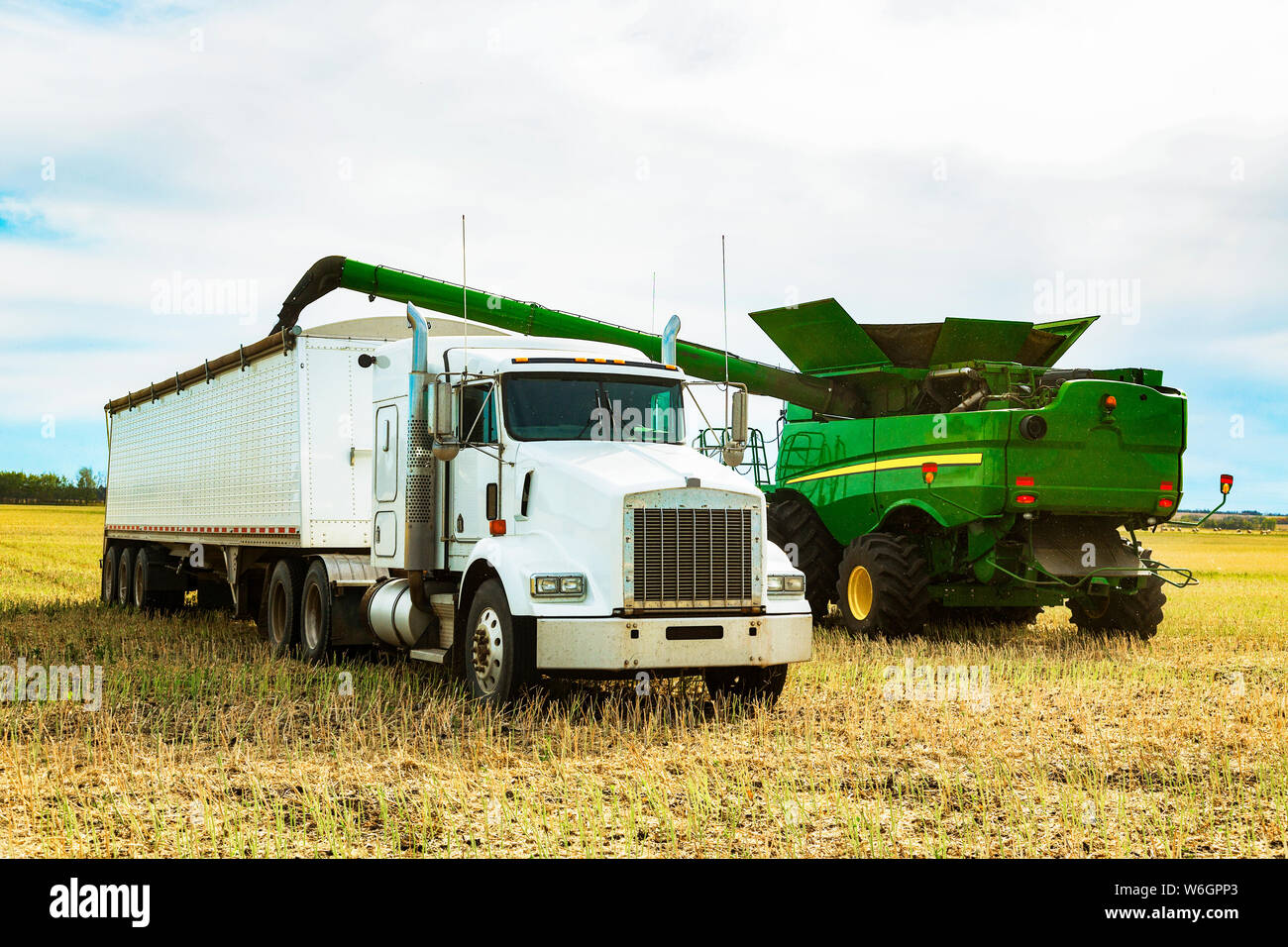 Combine harvester transferring load tractor hi-res stock photography ...