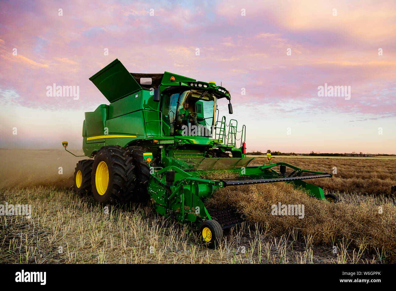 Combine driving into sunset hi-res stock photography and images - Alamy