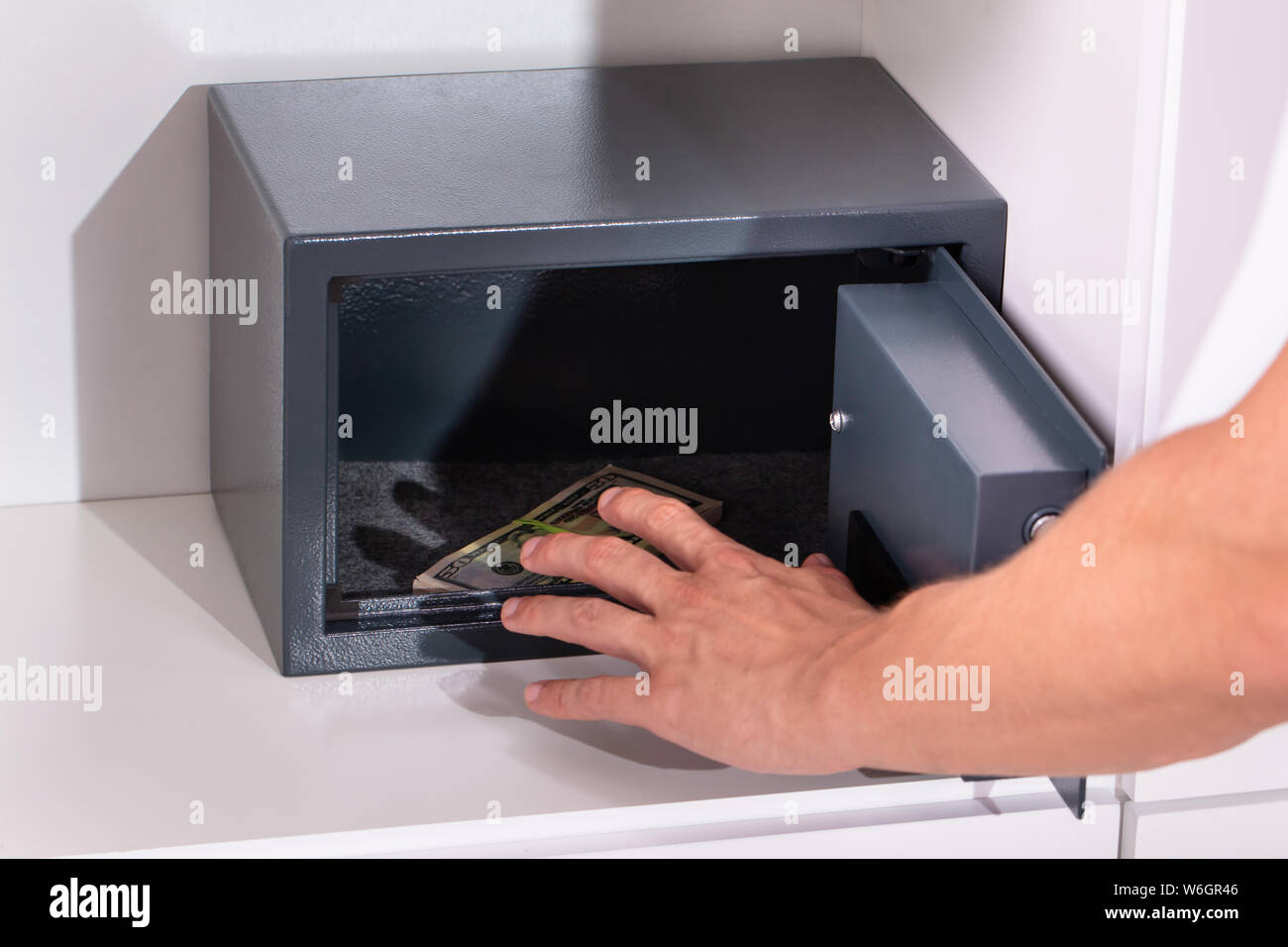 Close-up Of A Male Thief Stealing Banknotes From Open Safe Locker Stock ...
