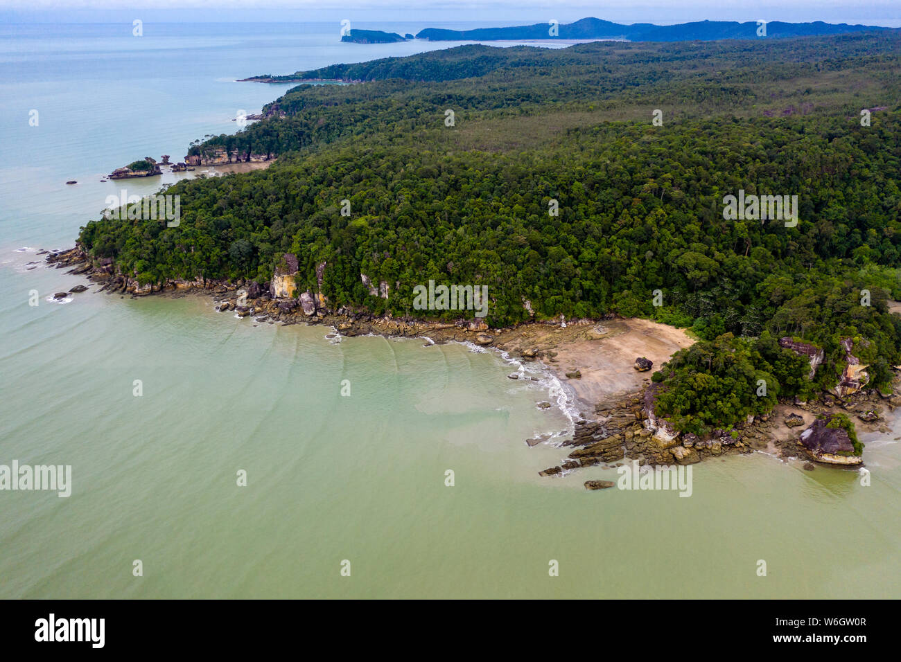 Aerial drone view of a deserted tropical sandy beach surrounded by ...