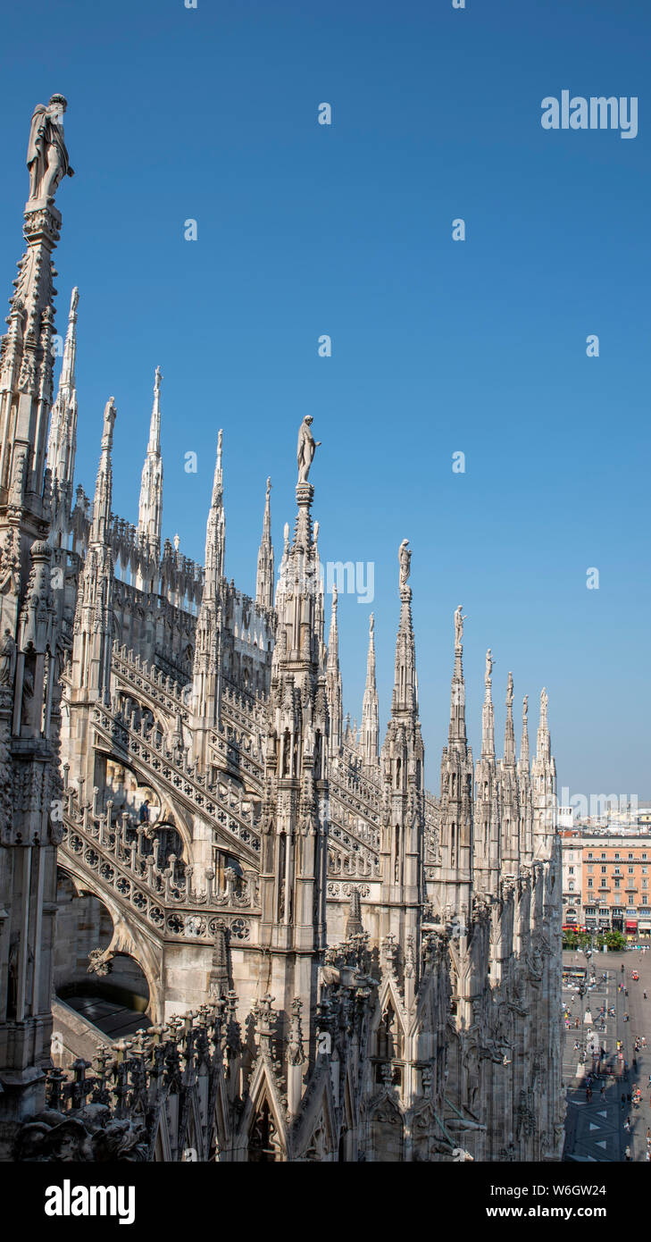 White marble statues on the roof of famous Cathedral Duomo di Milano on ...