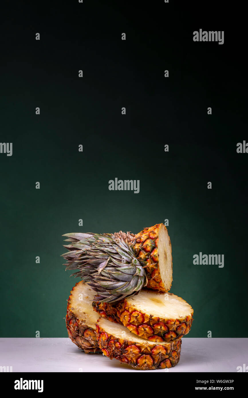 Entire pineapple sliced in several parts forming a pile with yellow ...
