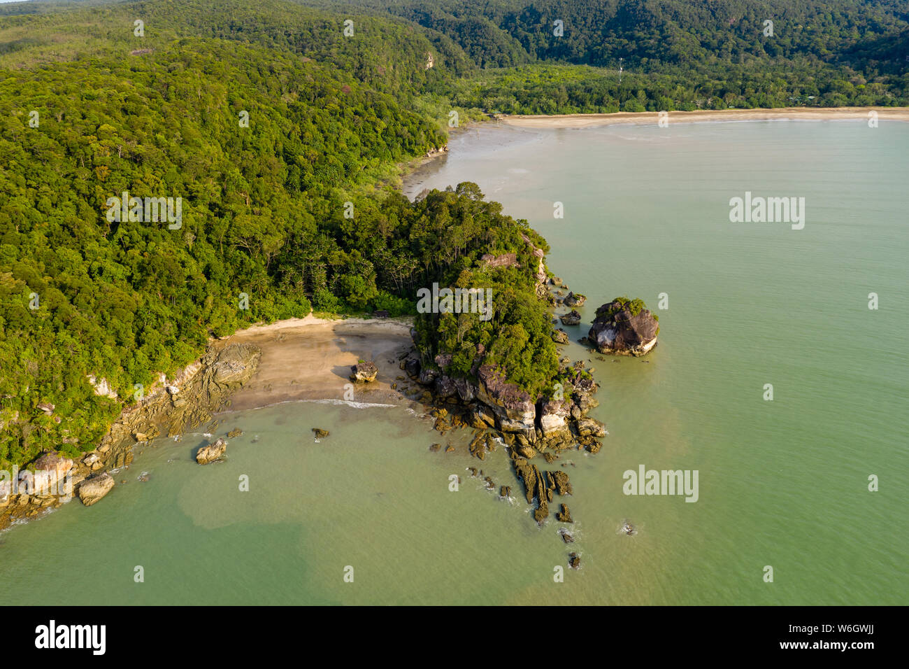 Aerial drone view of a beautiful small, deserted sandy beach in a small ...