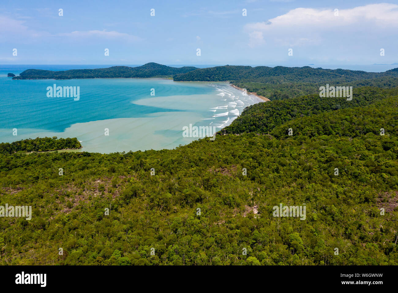 Aerial drone view of the remote tropical rainforest and coastline at ...