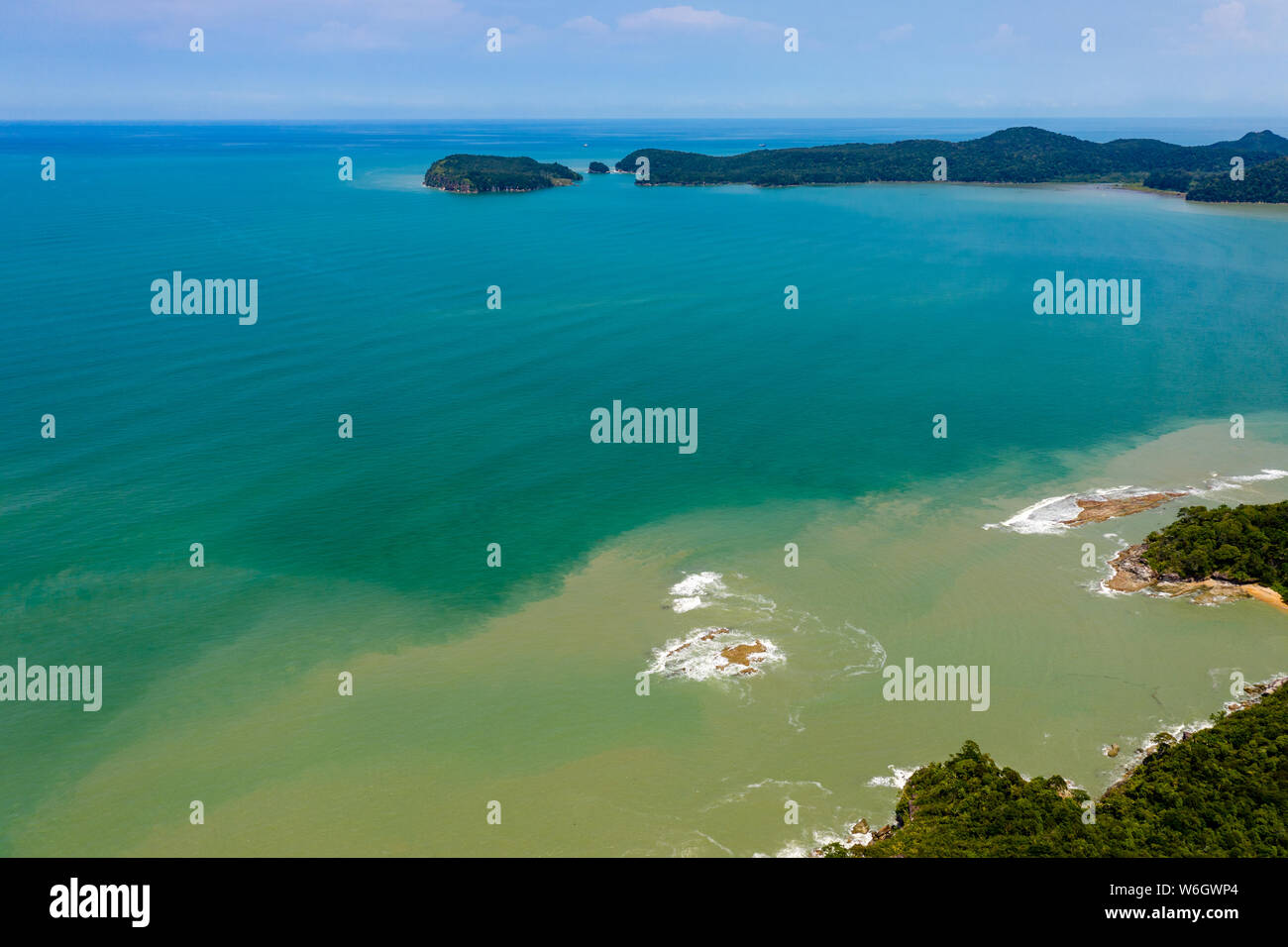 Aerial drone view of the remote tropical rainforest and coastline at ...