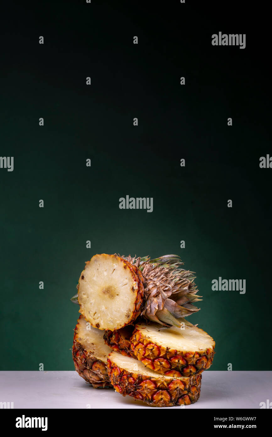 Entire pineapple sliced in several parts forming a pile with yellow ...