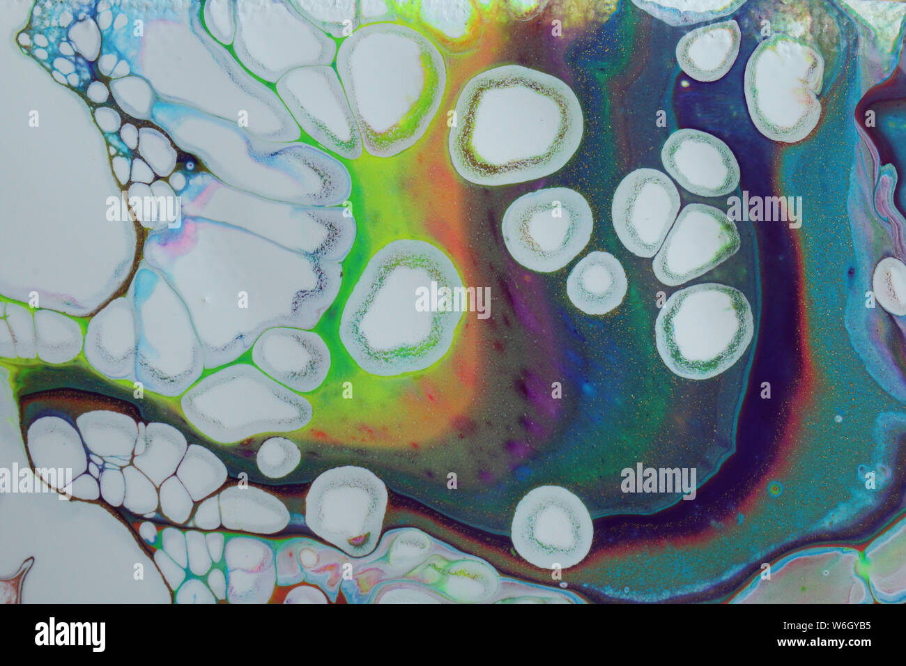 A rainbow of bright colors with white cells popping through to form a ...