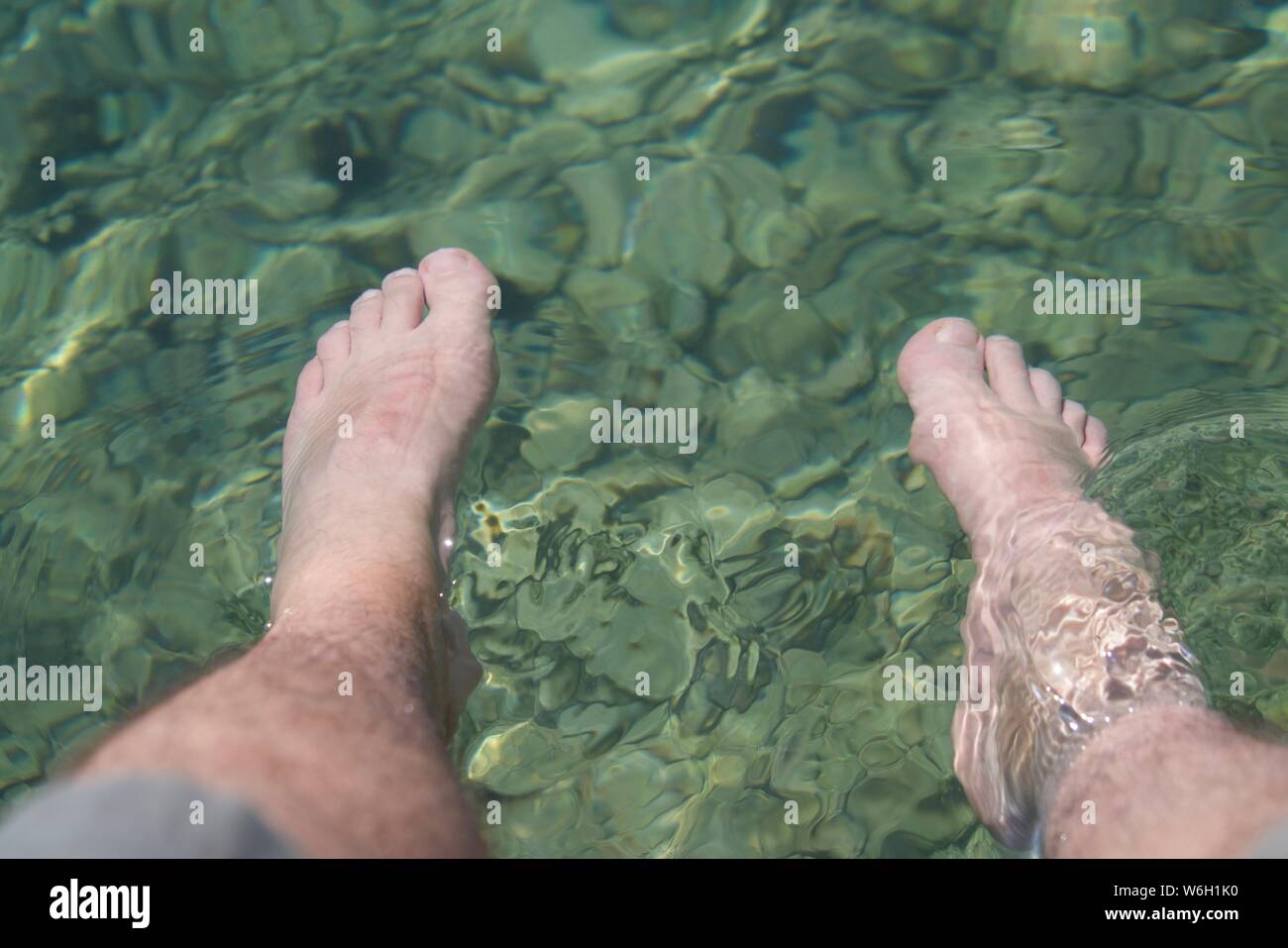People dipping feet in water hi-res stock photography and images - Alamy