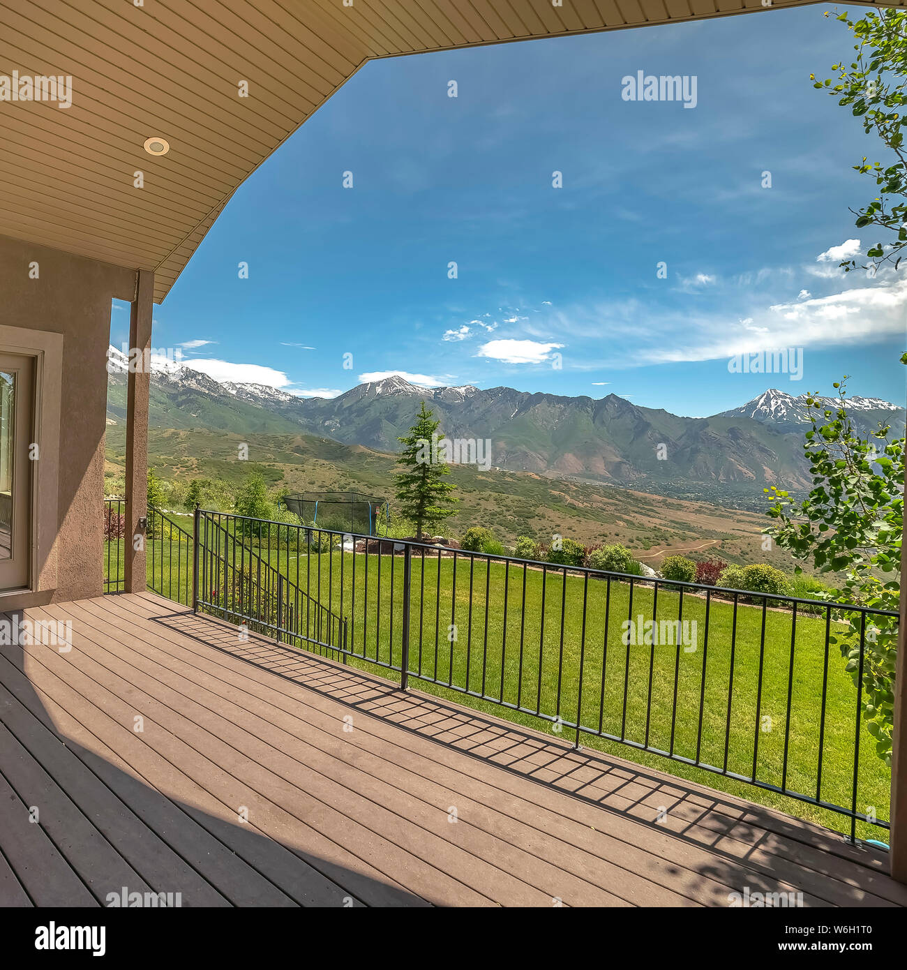 Square Home balcony with glass access door and stairs that leads to the ...