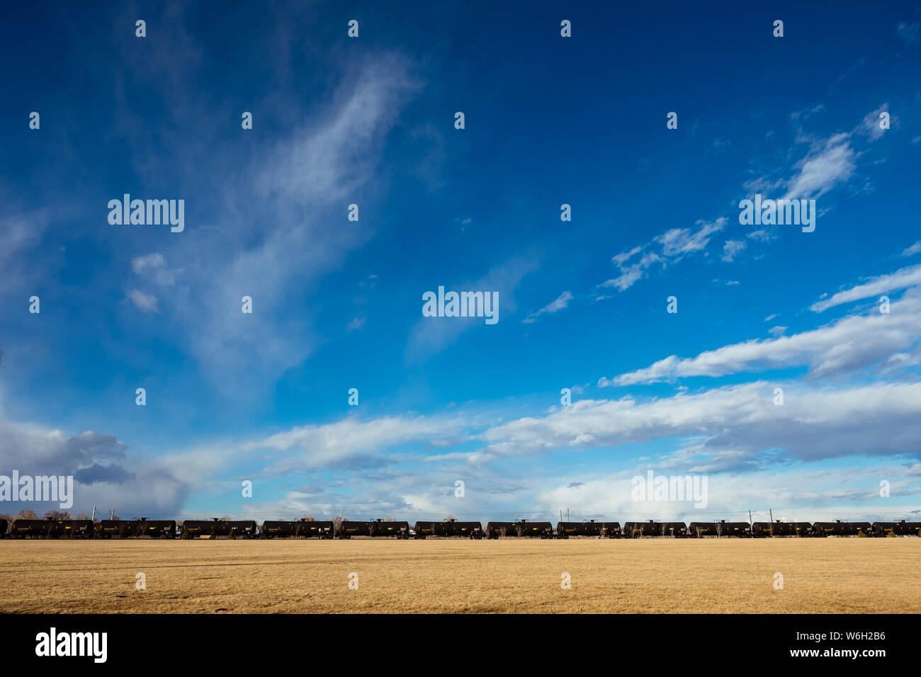 tanker train traveling across Colorado farm land under blue sky Stock ...