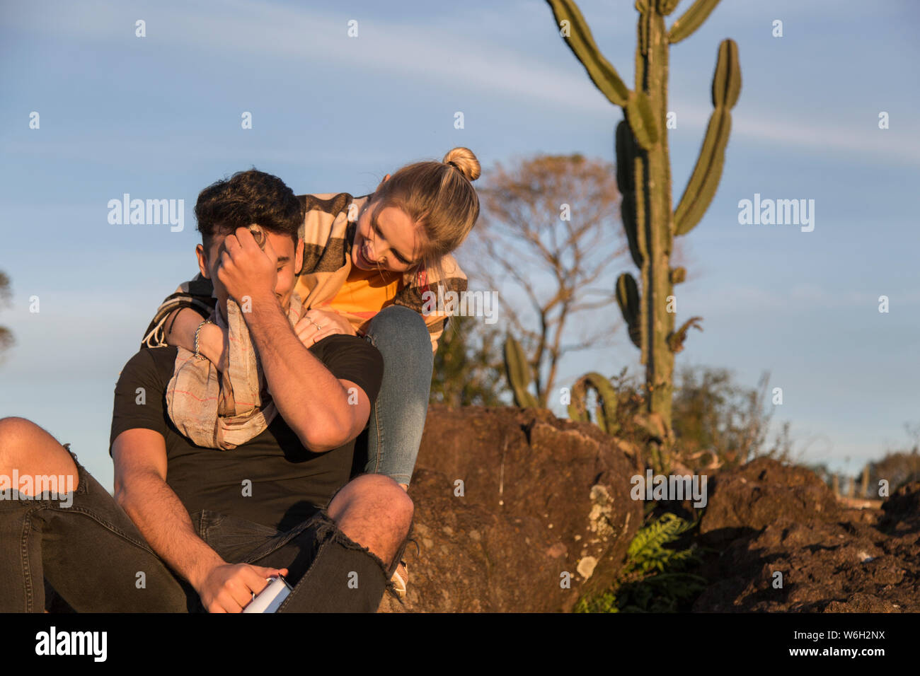 Woman sitting on cactus in hi-res stock photography and images - Alamy