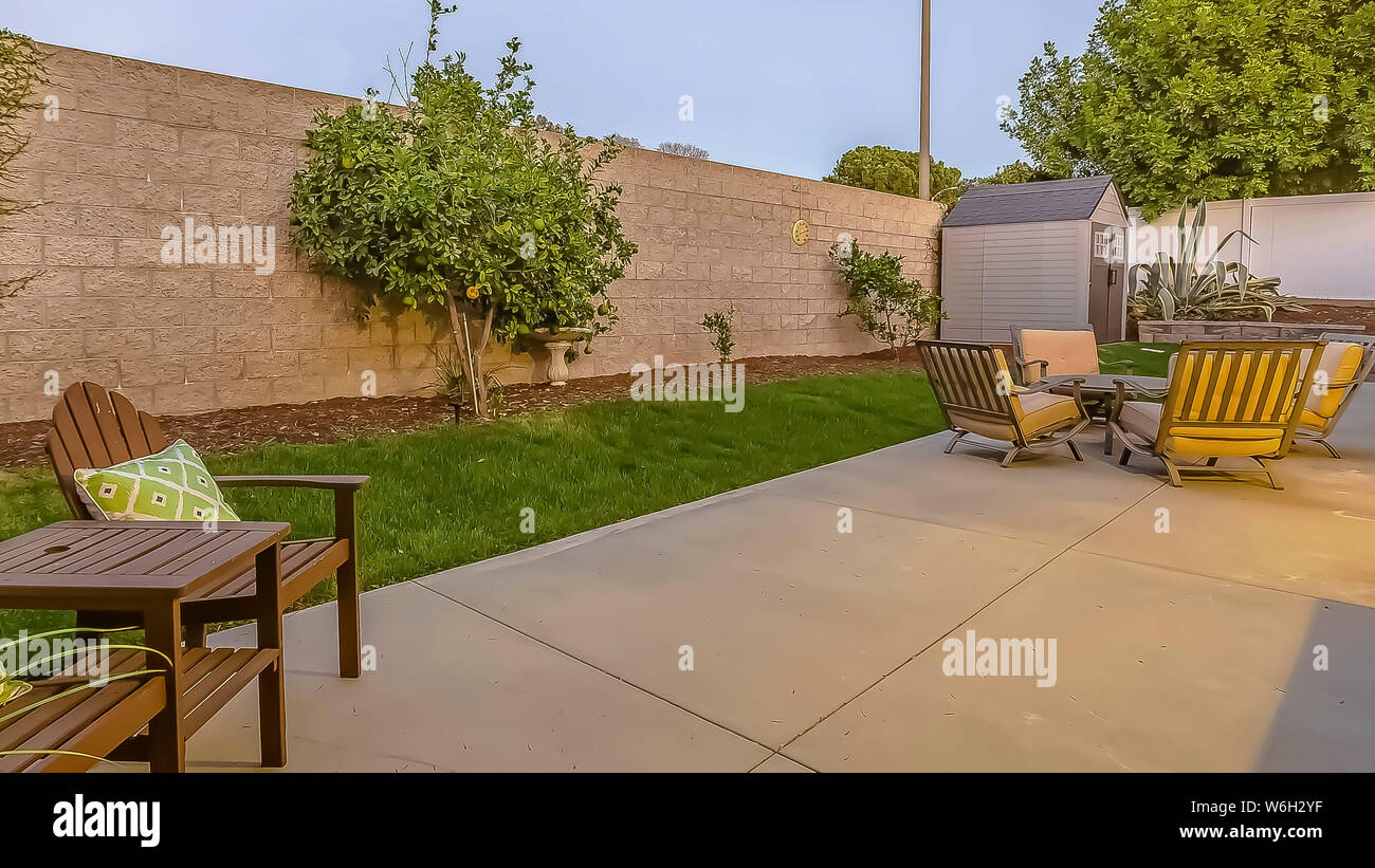 Panorama frame Spacious patio at the backyard of a home with a seating ...