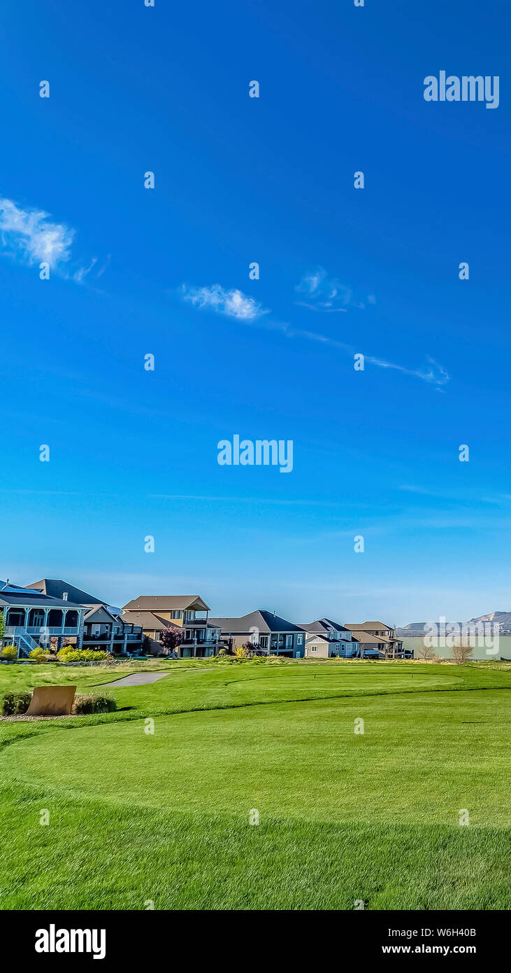 Vertical Homes and pathway on a vast field overlooking a lake and snow ...