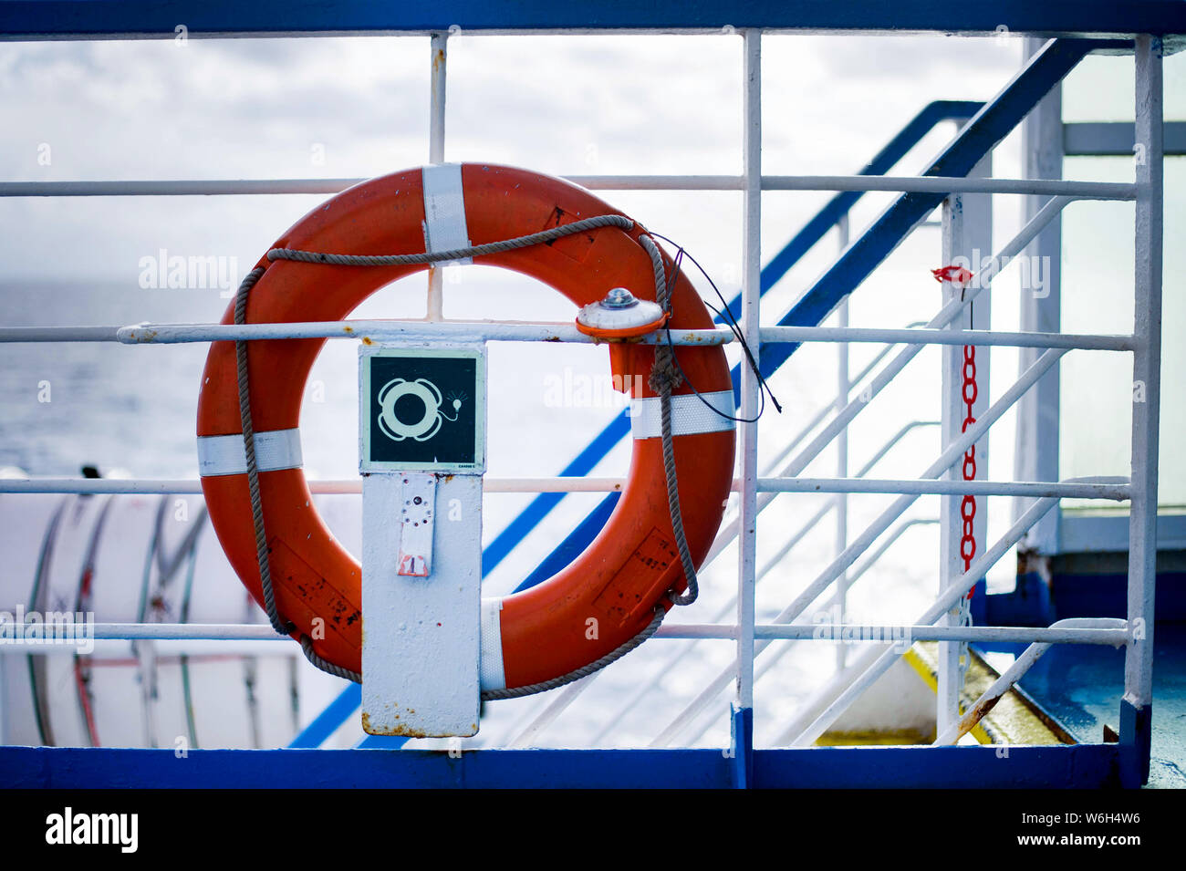 Red and white lifebuoy hanging on railing of ferry Stock Photo - Alamy