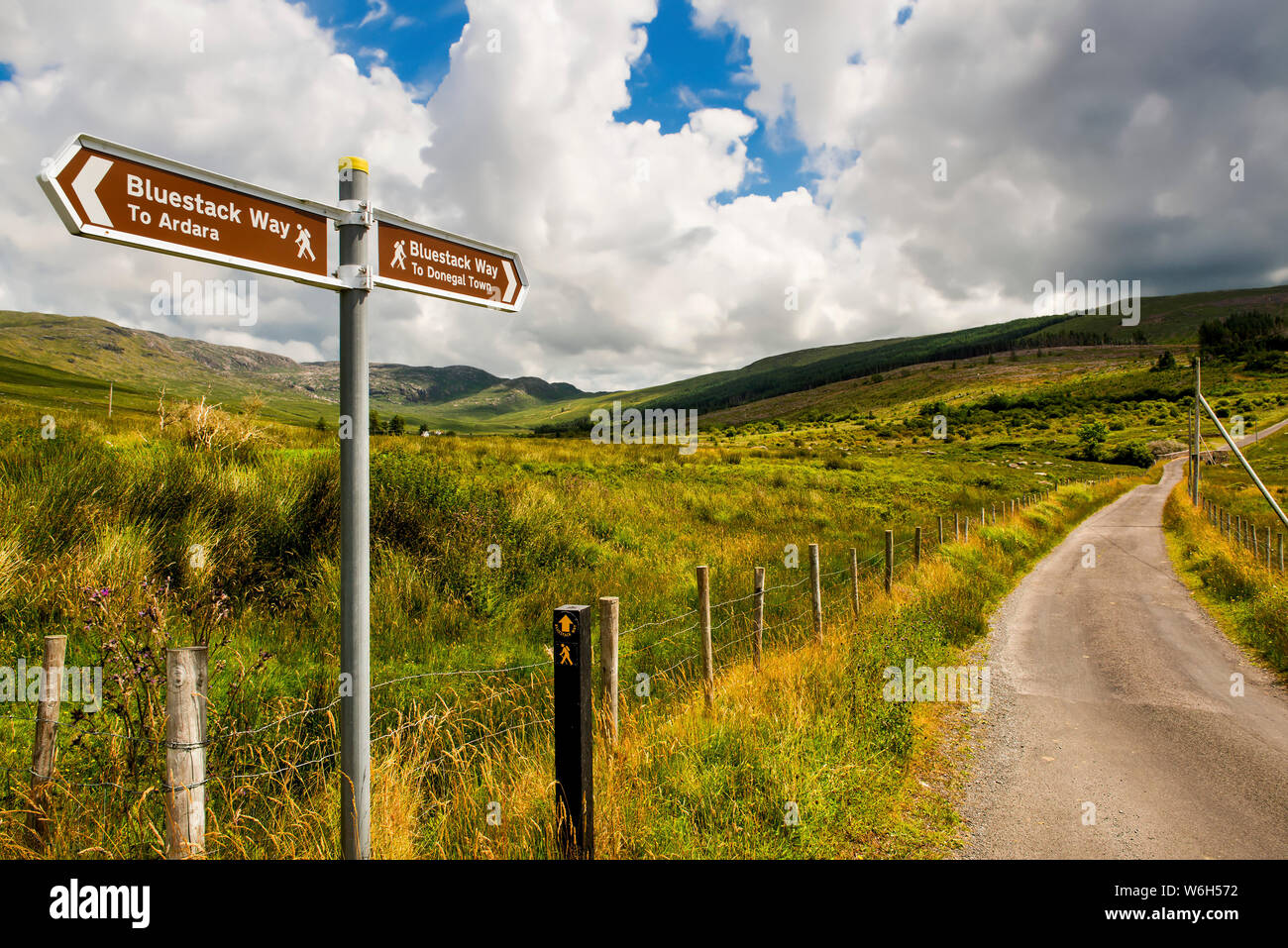 A sign for hiking trails, Bluestack Way, and a road leading through a ...