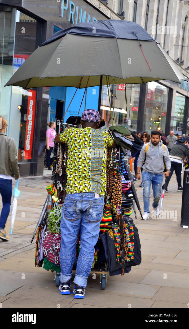 A seller of clothes and jewellery rom a mobile cart on Market Street ...
