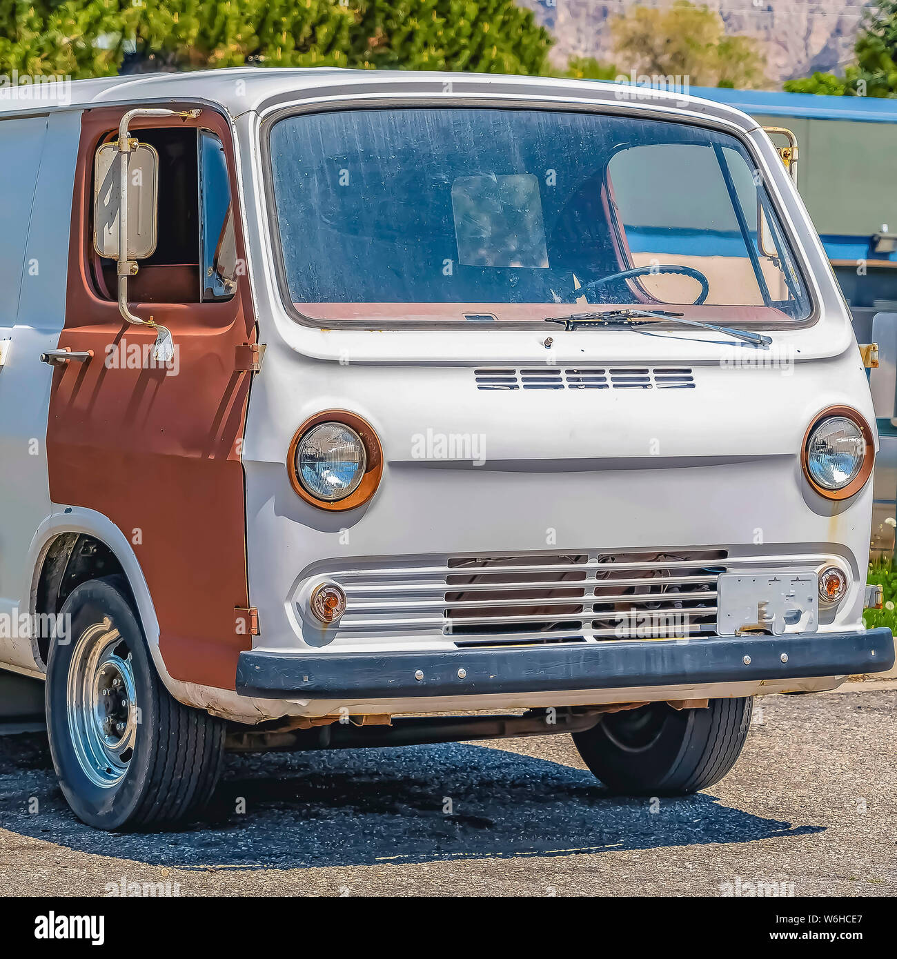 Square Front view of an old white van with brown door parked on ...