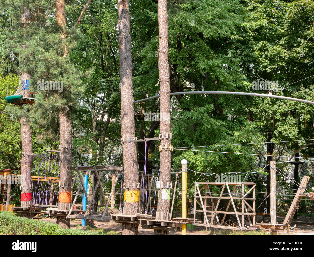 rope climbing amusement adventure park on trees in forest Stock Photo ...