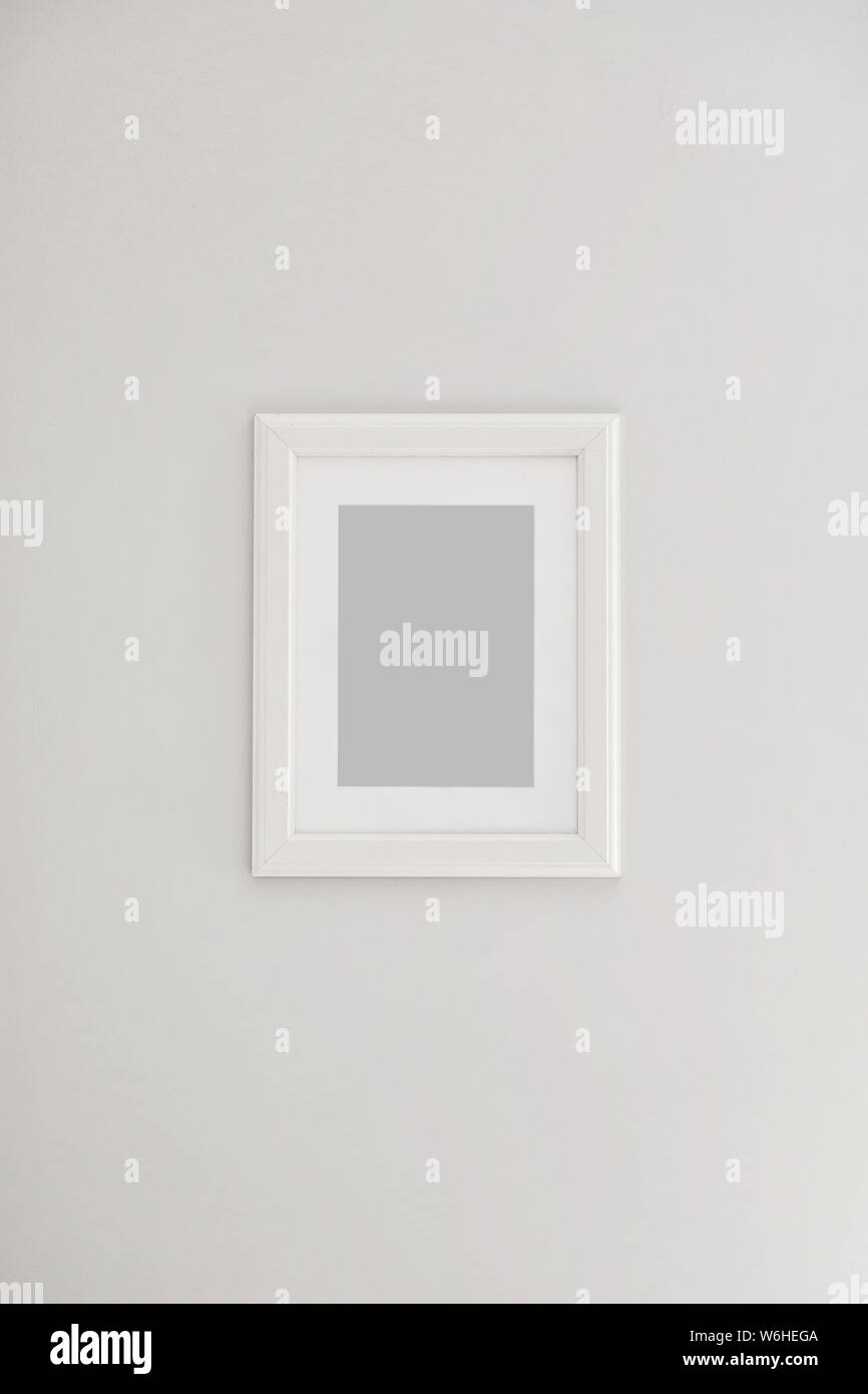 Rectangular vertical white frame for paintings on a gray wall Stock ...