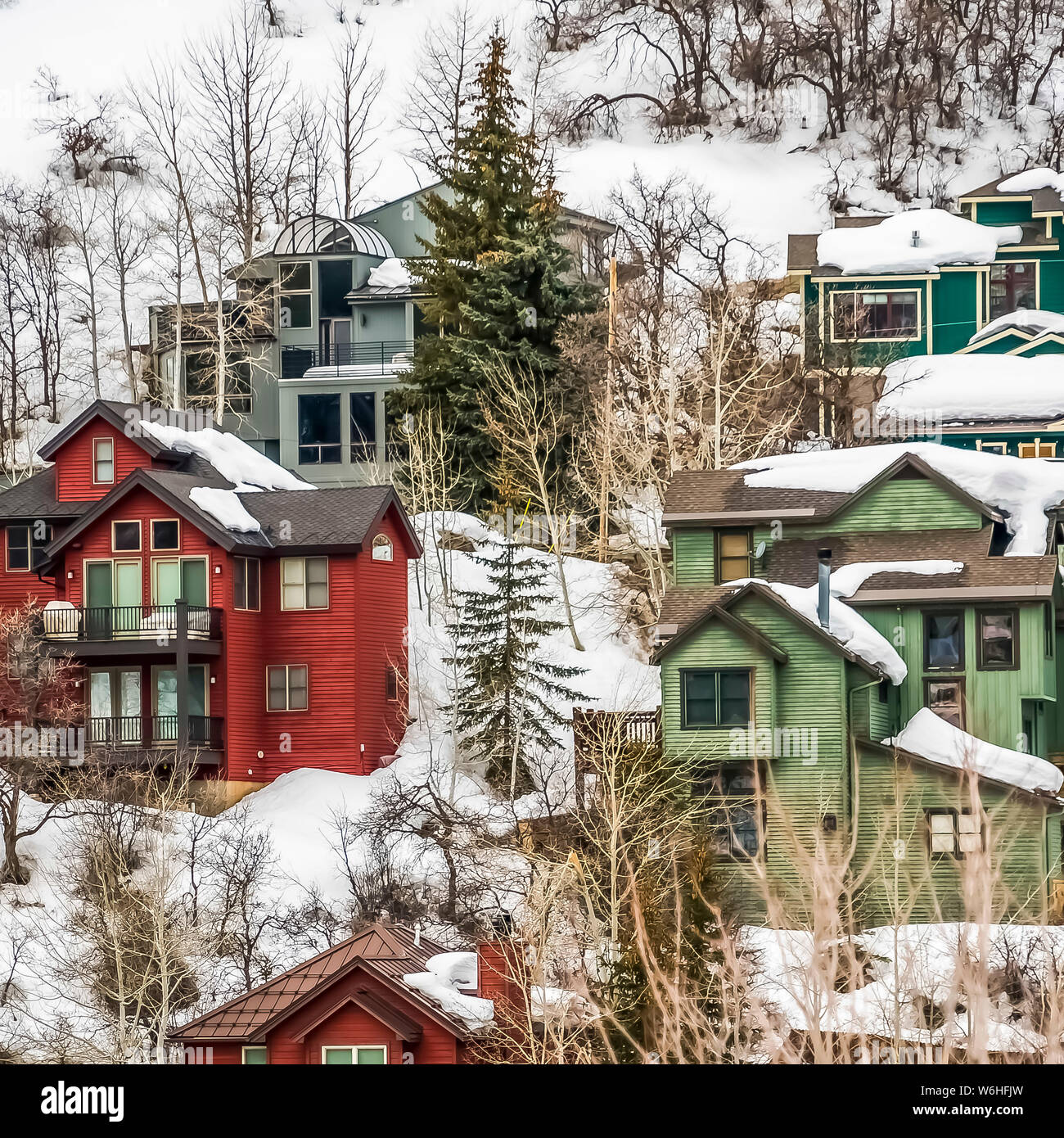 Square Scenic winter landscape with colorful houses built on the snowy ...