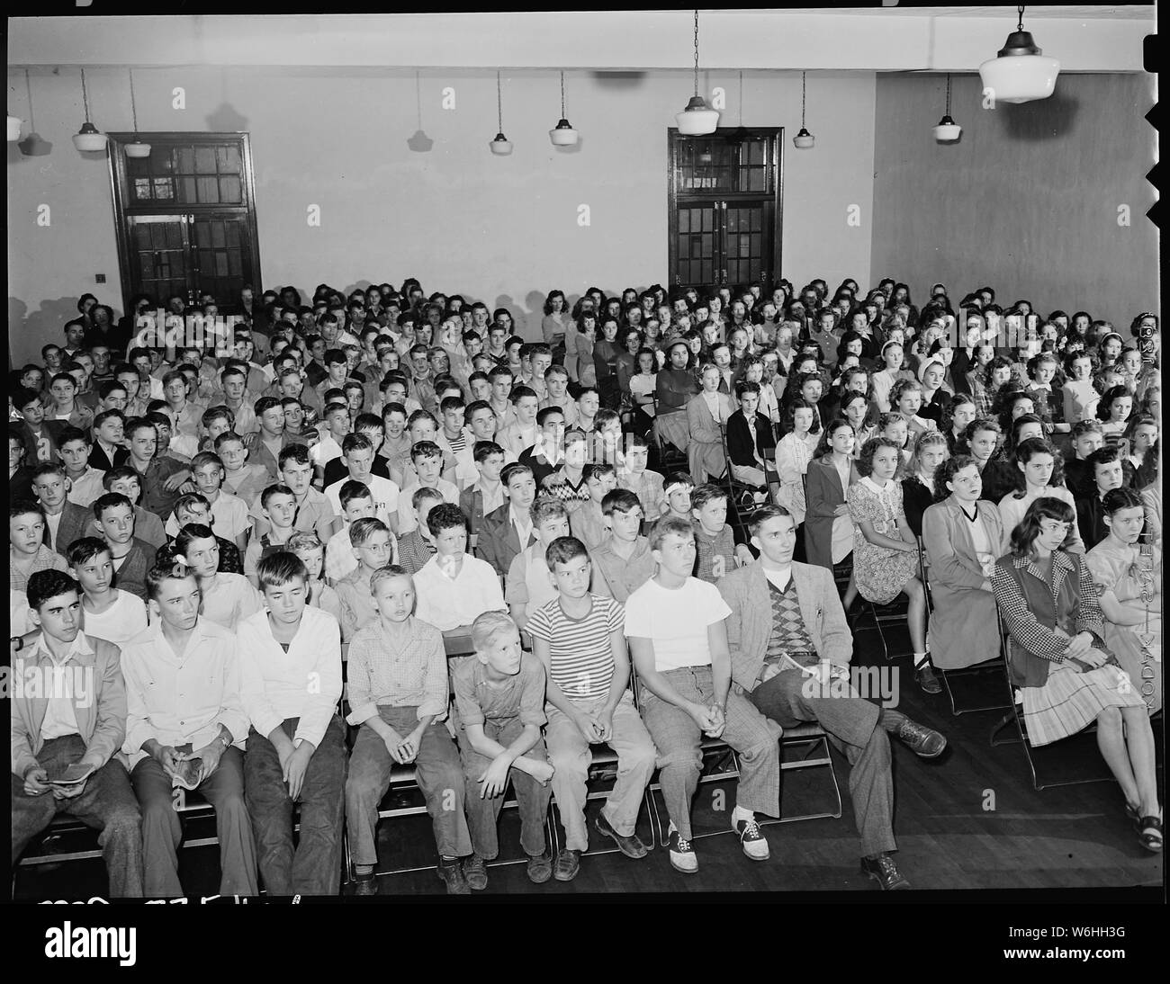 High school students in auditorium. School is adjacent to property of ...