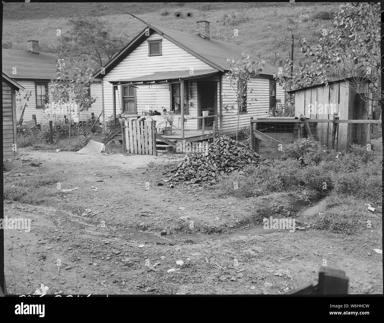 Home of miner in company housing project. Notice drainage in street ...