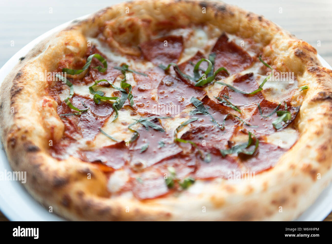 pepperoni pizza sits on a white plate Stock Photo - Alamy