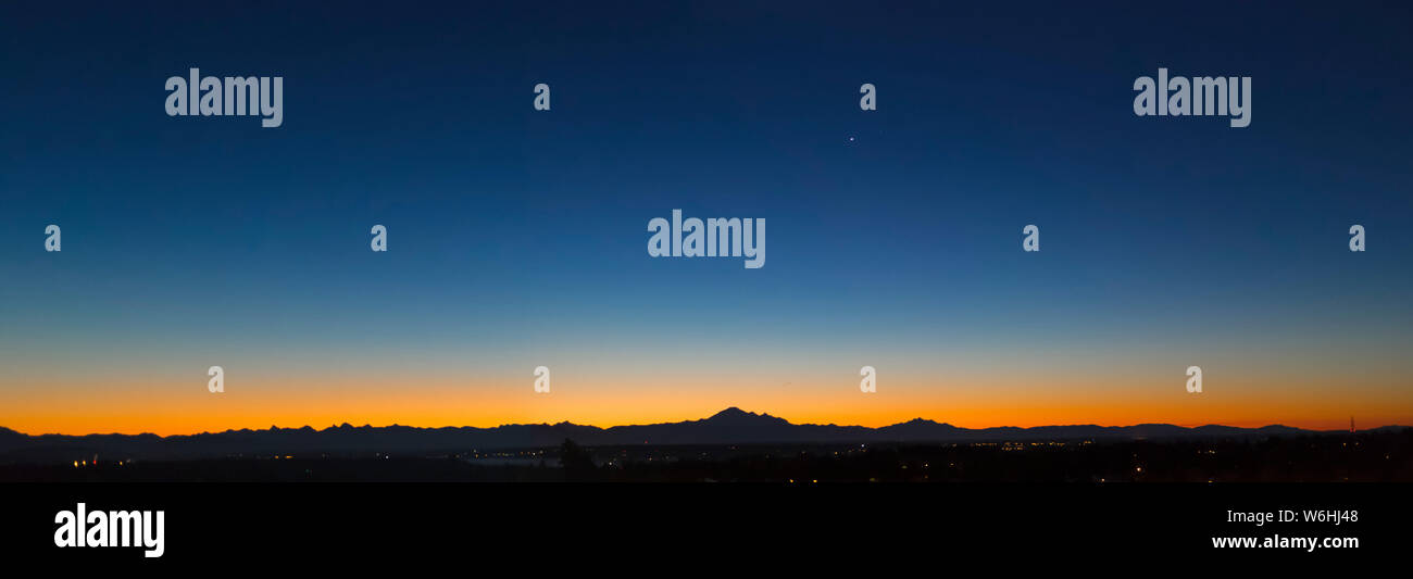 Sunset glowing over the horizon with a blue, starry sky; Surrey ...
