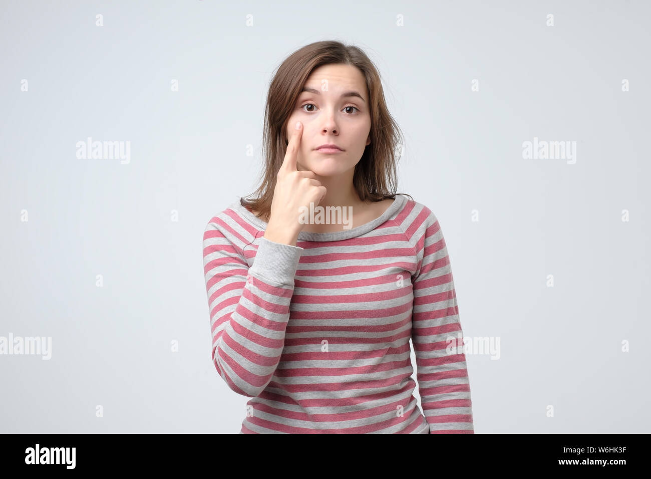 Young caucasian woman suffering from eyes fatigue Stock Photo - Alamy