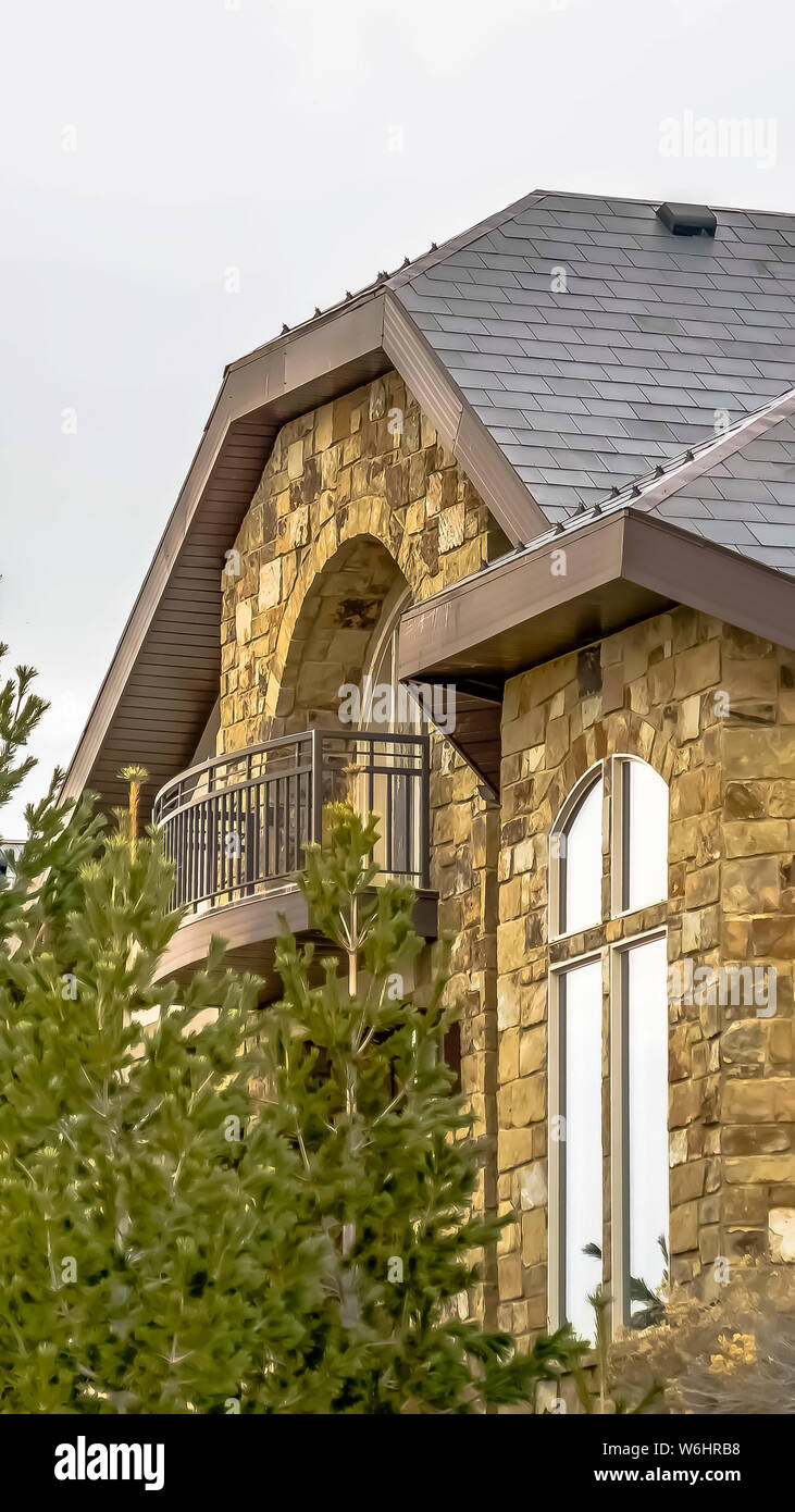 Vertical frame Stone home with half circle balcony and quarter round ...