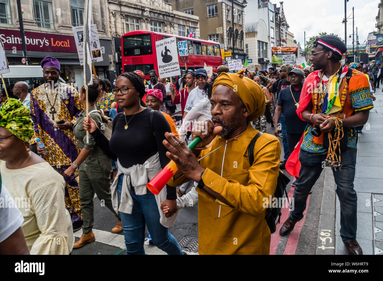London, UK. 1st August 2019. People of African origin line from Brixton ...