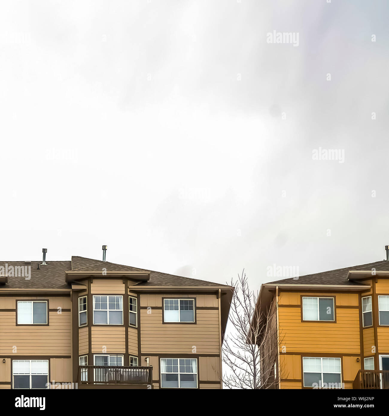Square Overcast sky over homes with balconies and half hexagon shaped ...
