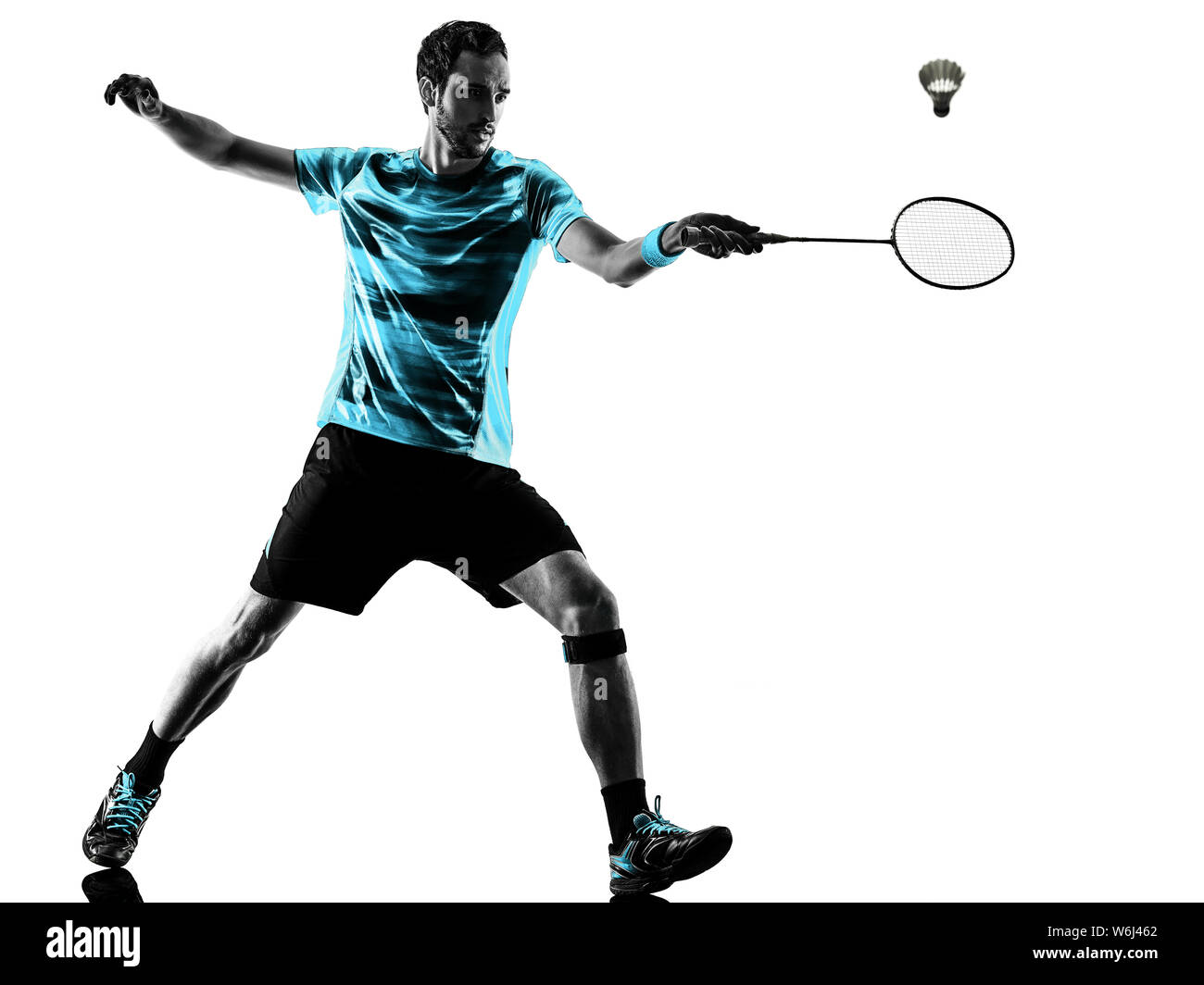 one caucasian Badminton player man in studio shadow silhouette isolated ...