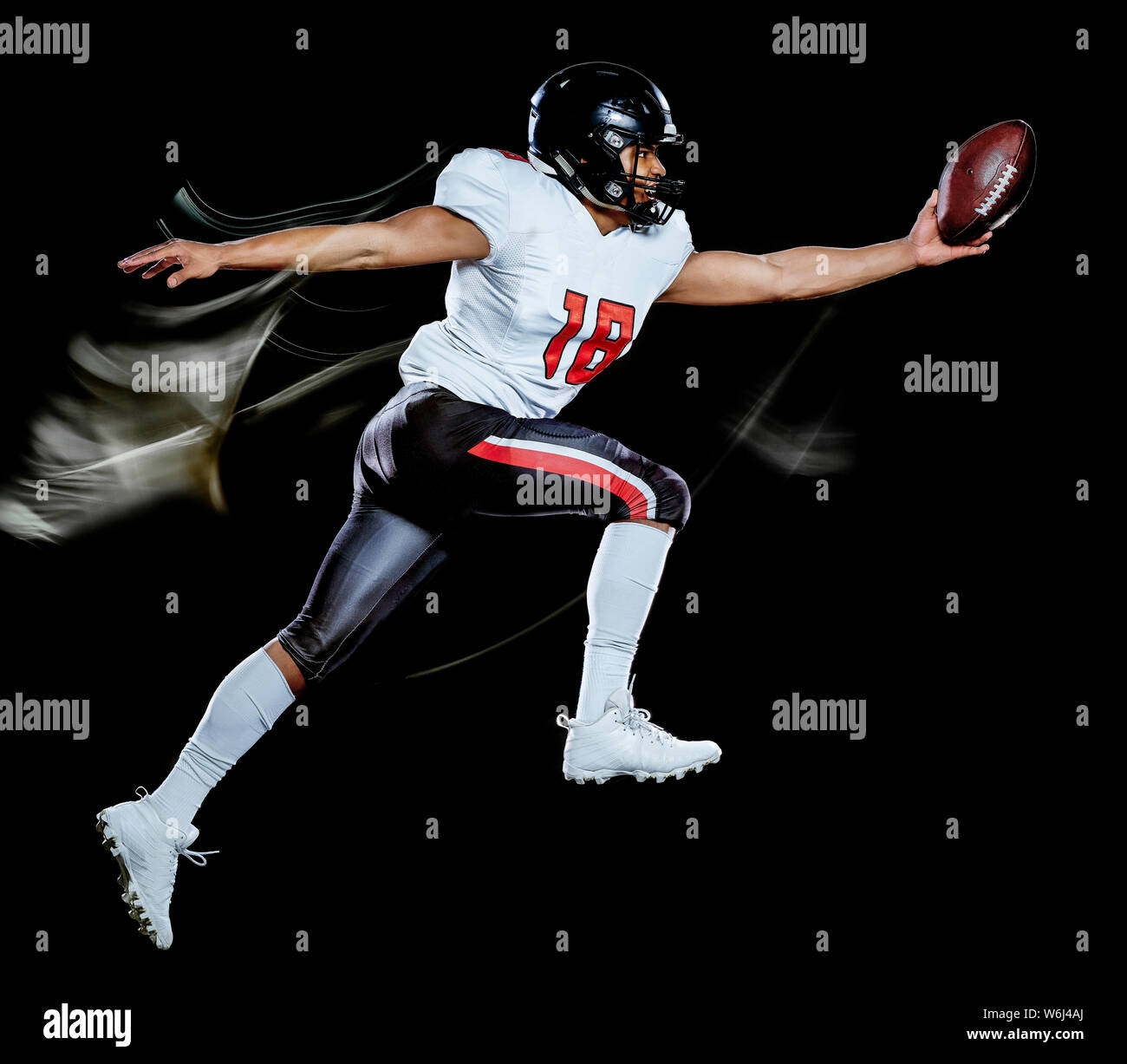 one african american football player man studio shot isolated on black ...